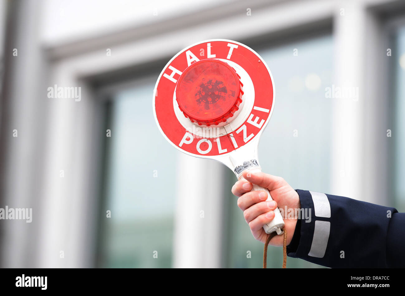 Freiburg, Germany. 22nd Jan, 2014. ILLUSTRATION - A policeman holds a ...