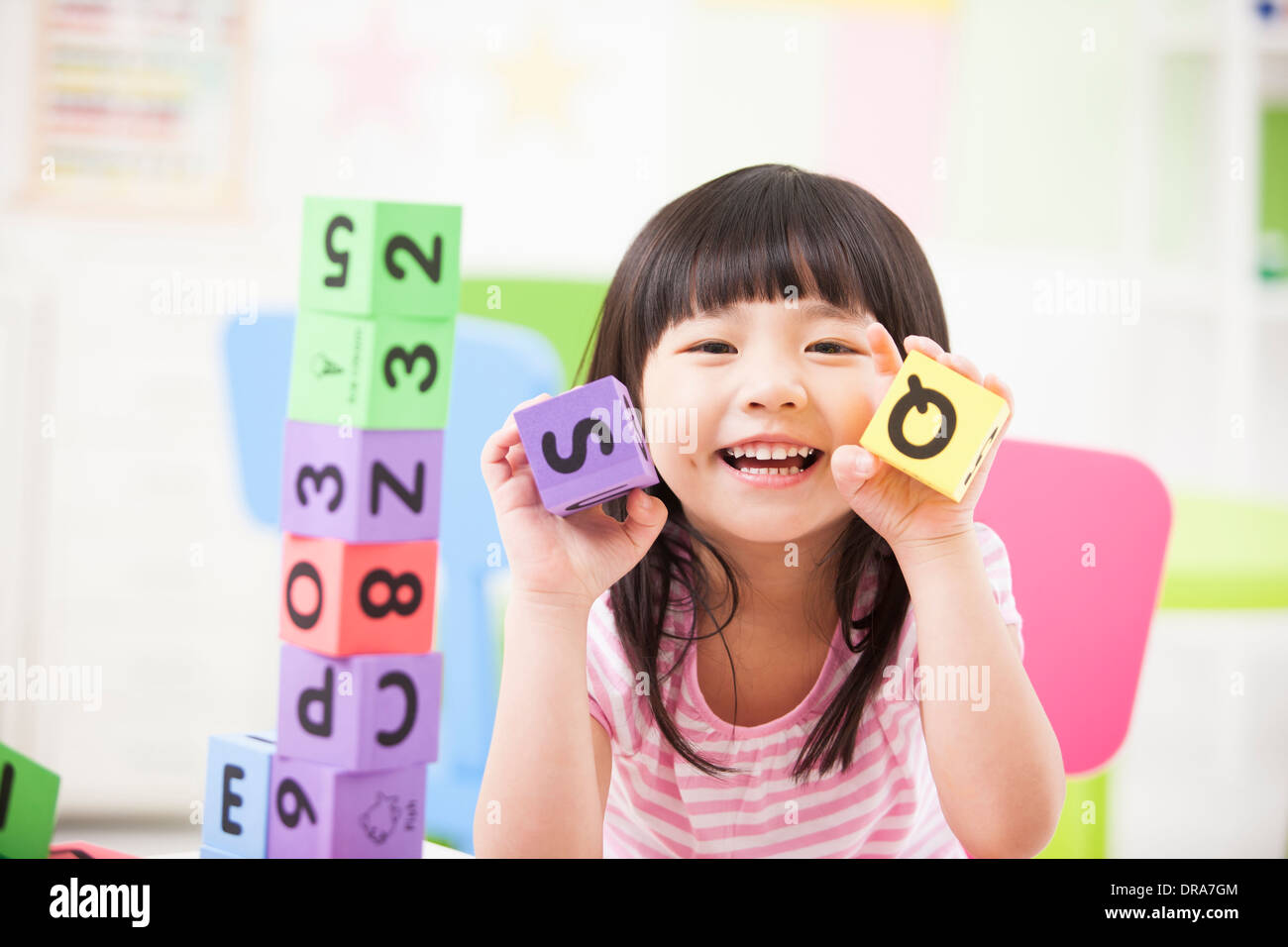 a kid playing with toy cubes Stock Photo - Alamy