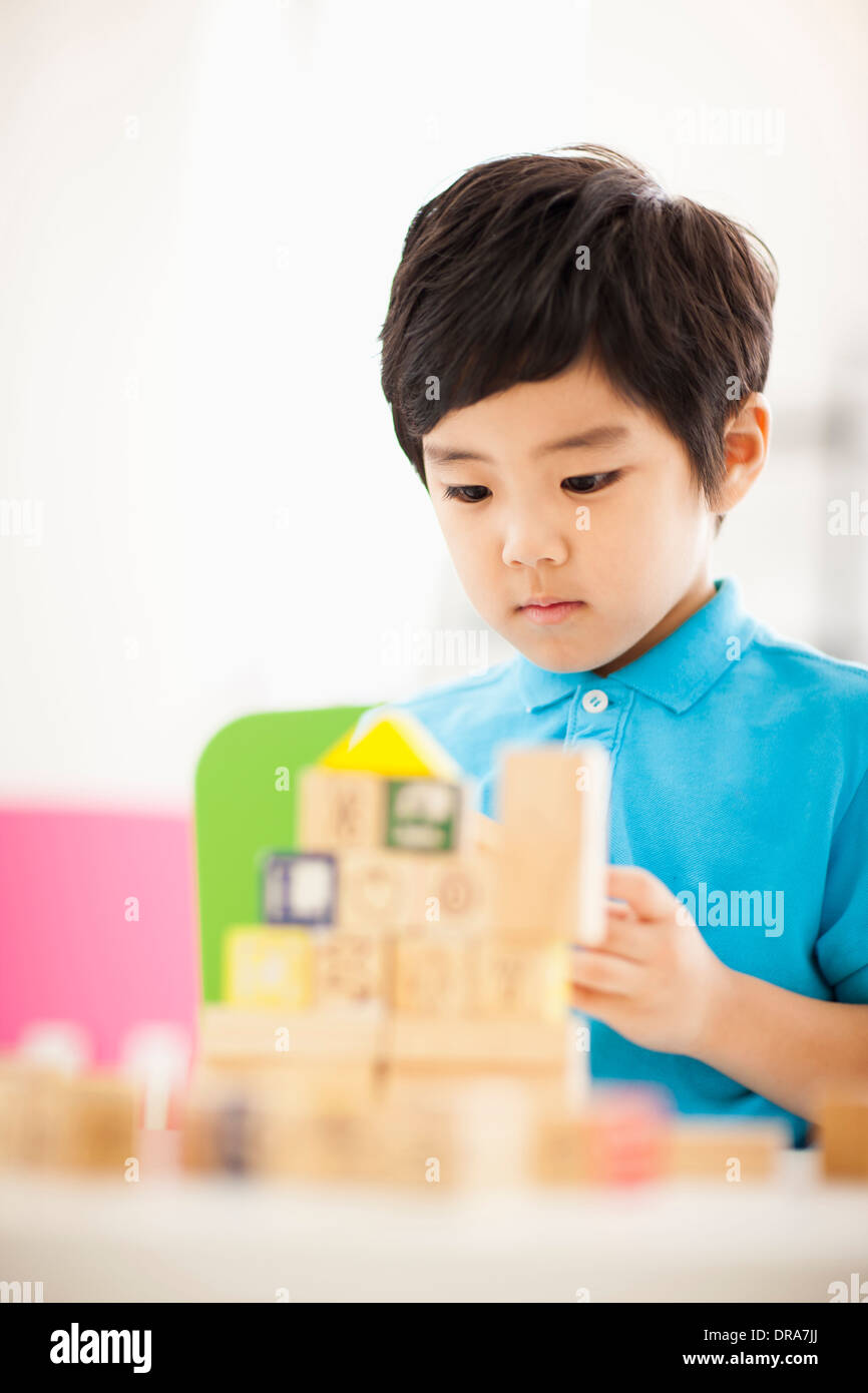a boy playing with wood cubes with icons Stock Photo - Alamy