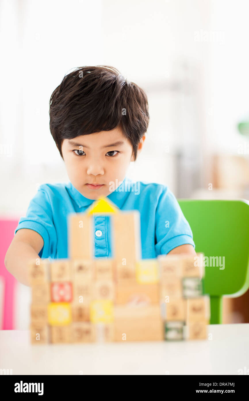 a boy playing with wood cubes with icons Stock Photo - Alamy