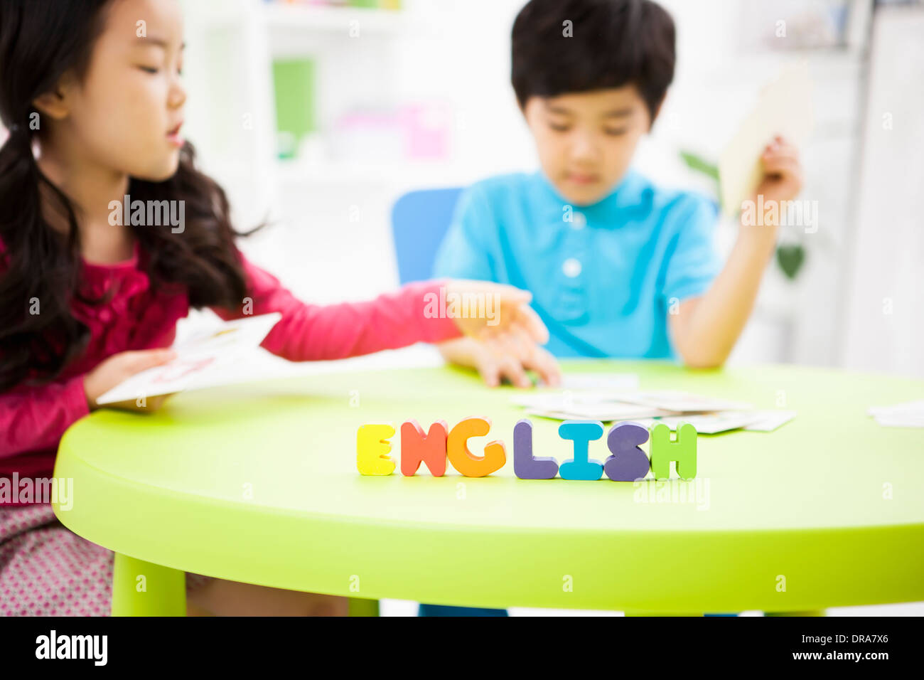 kids learning English with toys at table Stock Photo - Alamy