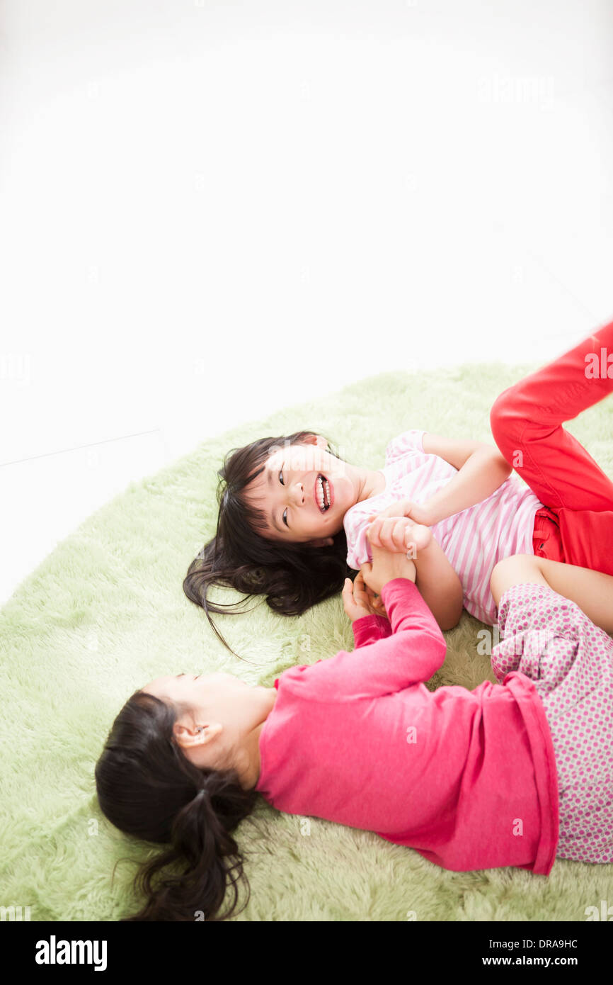 kids lying on a carpet playing Stock Photo - Alamy