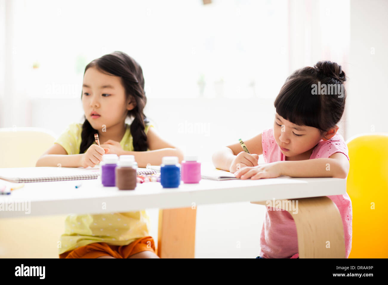 kids at table with sketchbooks and crayons Stock Photo - Alamy