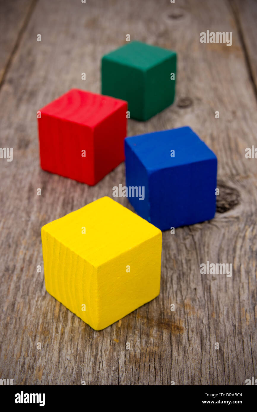 Wooden colored cubes on the old floor Stock Photo - Alamy