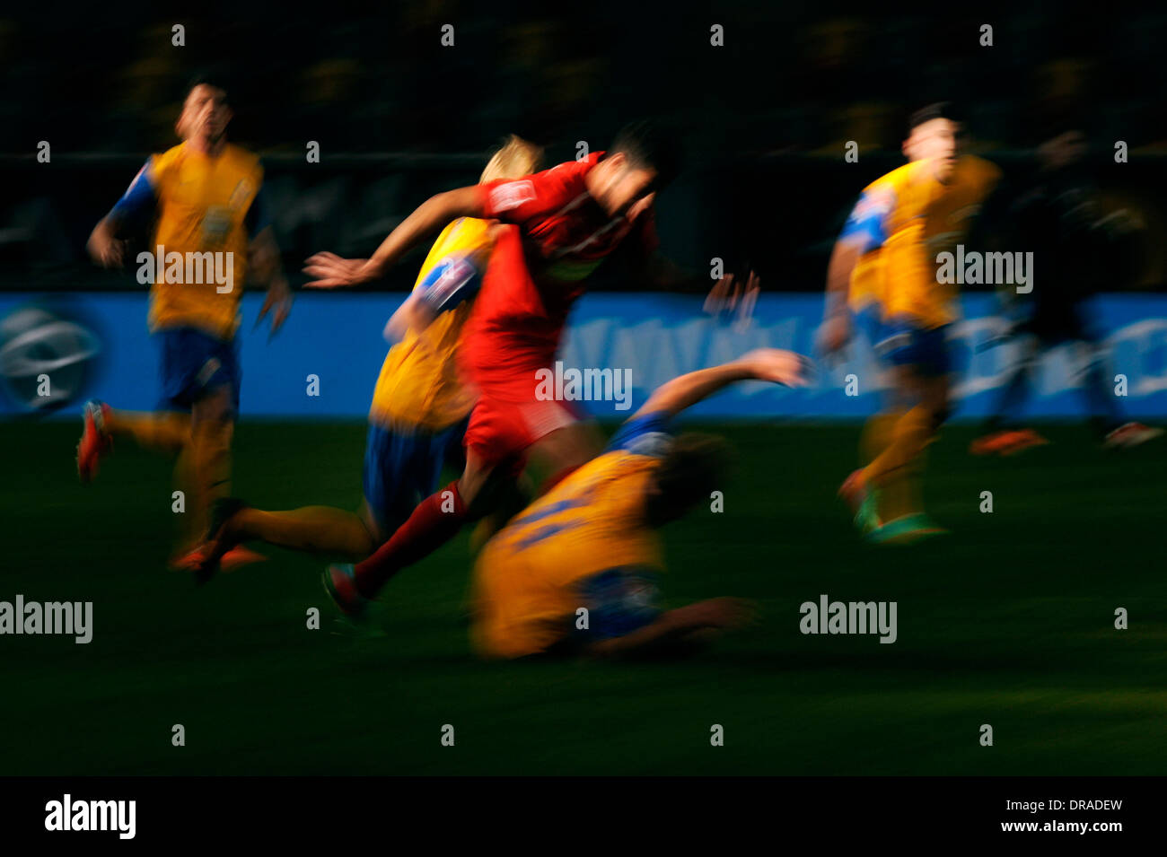 Blurred football players in red and yellow Stock Photo - Alamy