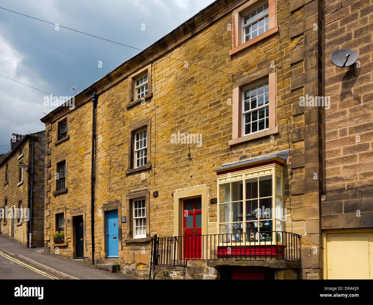 Traditional stone built terraced cottages on a hillside in Bakewell ...