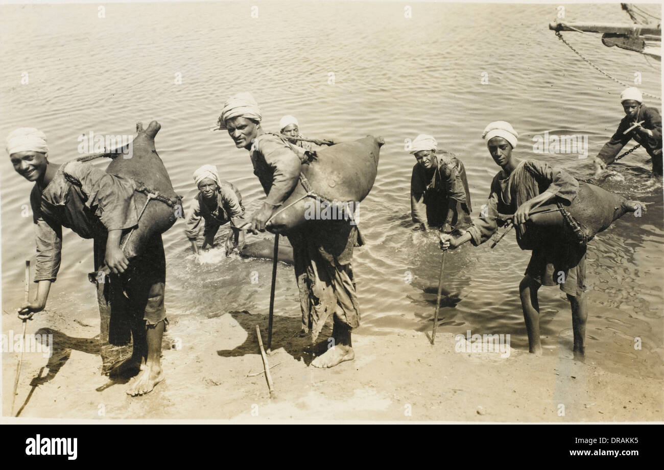Egypt - River Nile - Water carriers fill their water skins Stock Photo ...