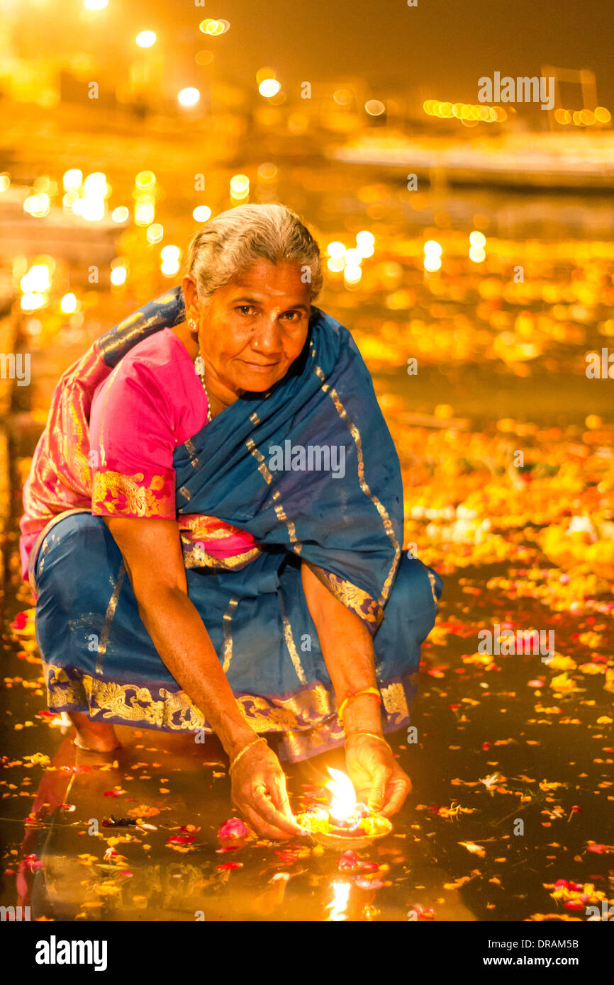 Old woman holding candle Stock Photo - Alamy