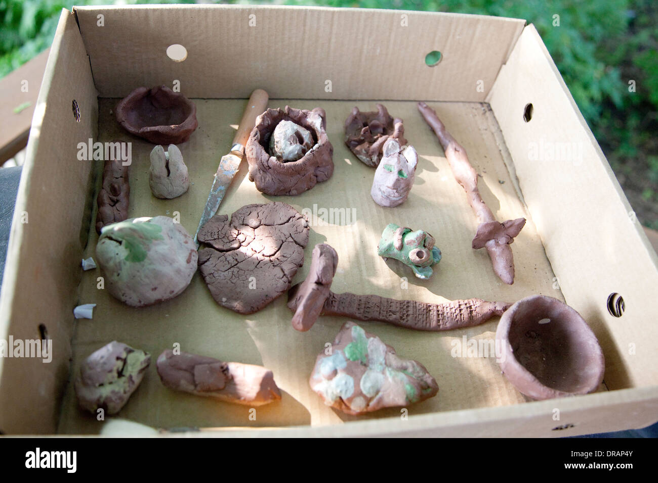 Box of finished modeled clay items made in children's pottery class ...