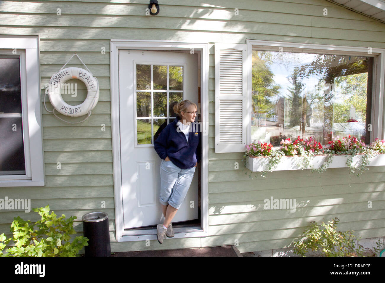 Owner of Bonnie Beach Resort musing at entrance to quaint snack and ...