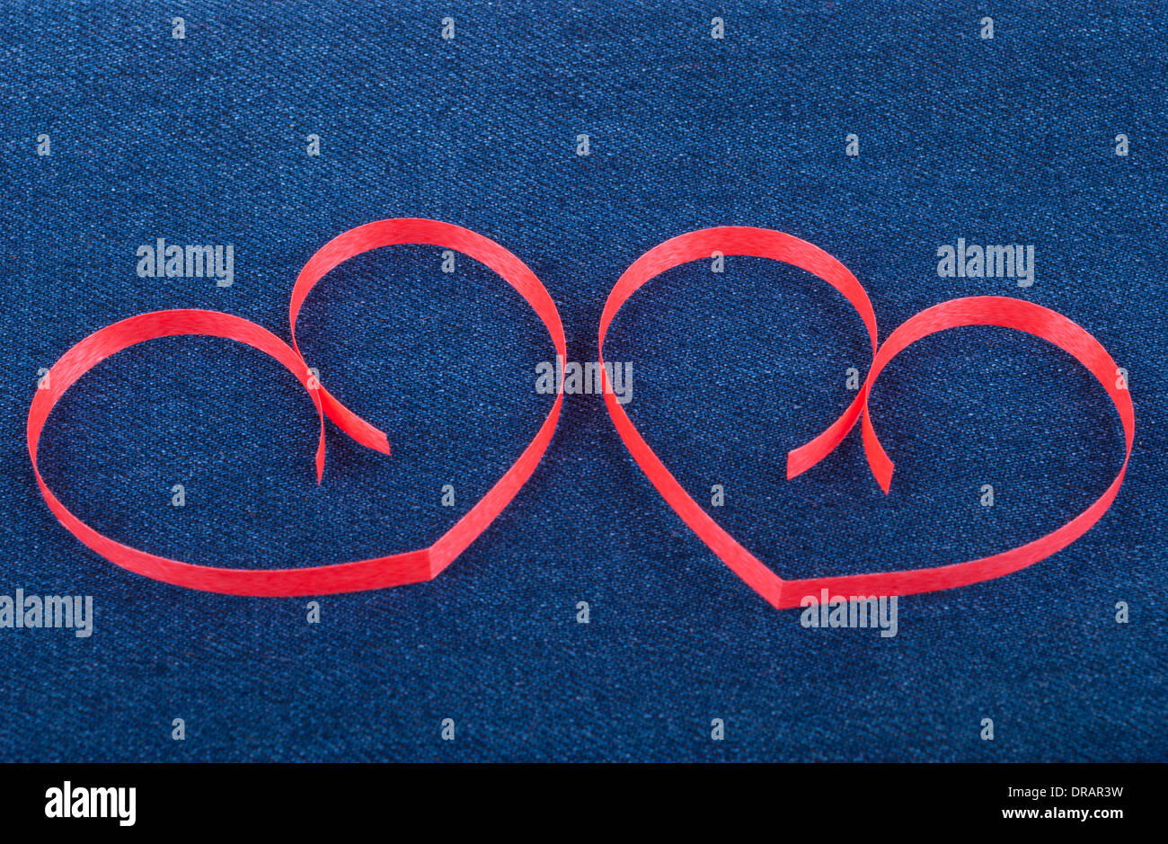 Two paper hearts on jeans background Stock Photo - Alamy
