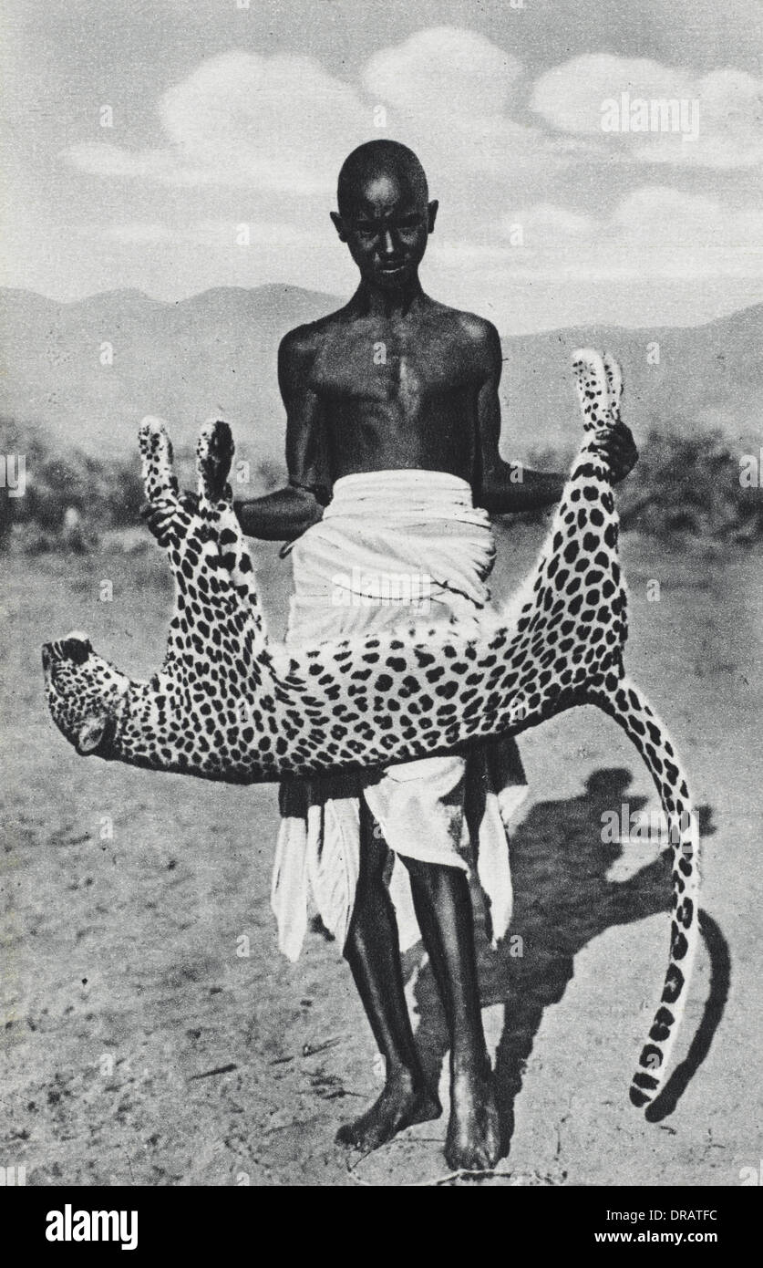 East Africa - Native hunter with a captured Leopard Stock Photo - Alamy