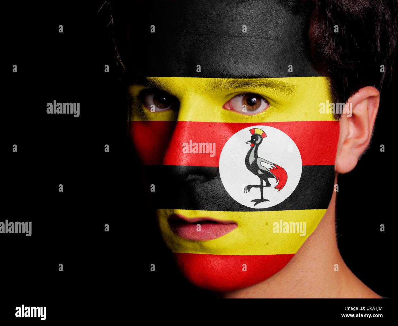 Flag of Uganda Painted on a Face of a Young Man Stock Photo - Alamy