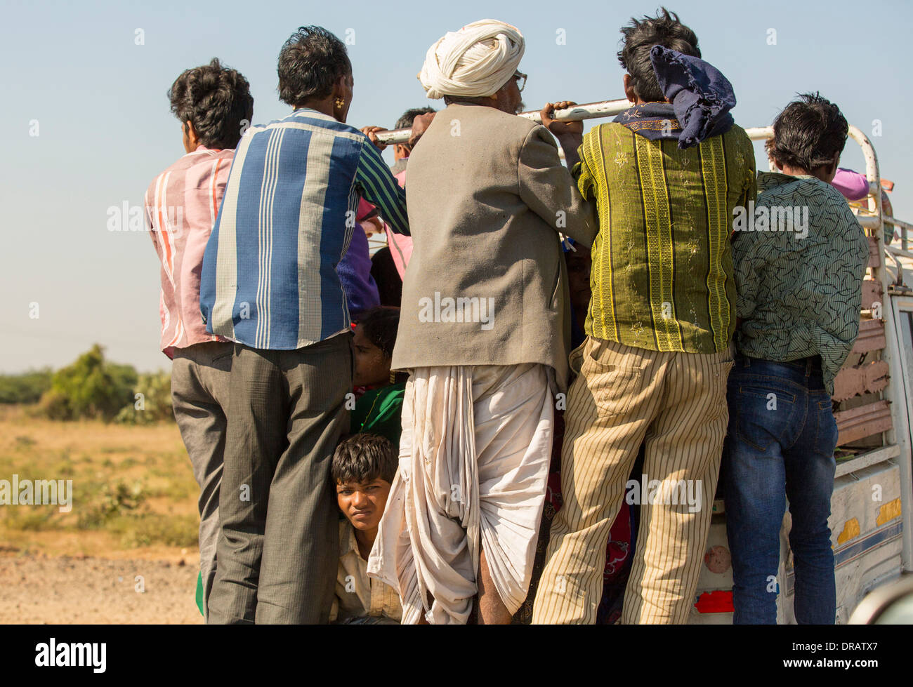 Driving in India with people hanging off the back of a vehicle ...