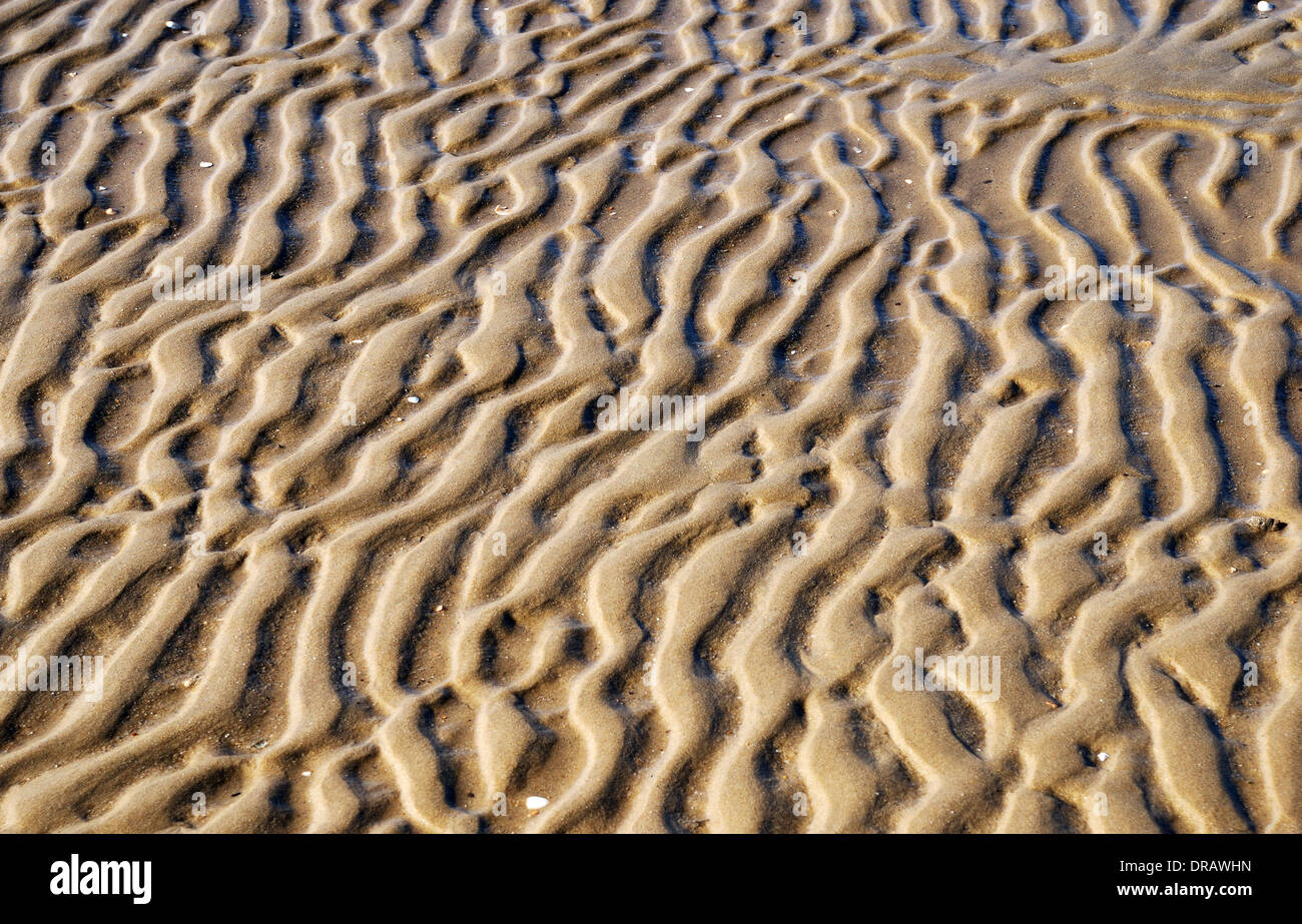 Wavy pattern of wet sand on the beach Stock Photo - Alamy
