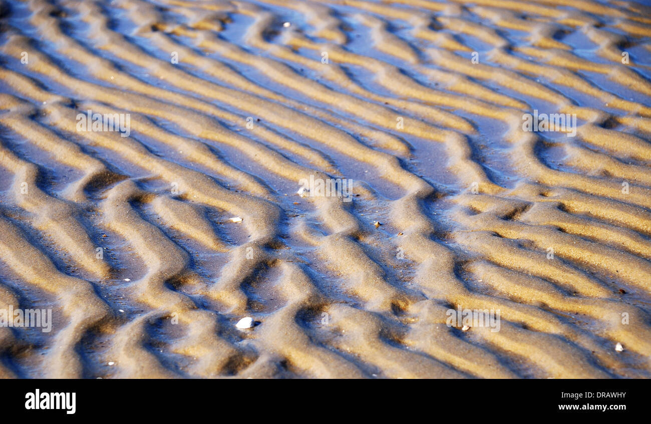 Wavy pattern of wet sand on the beach Stock Photo - Alamy