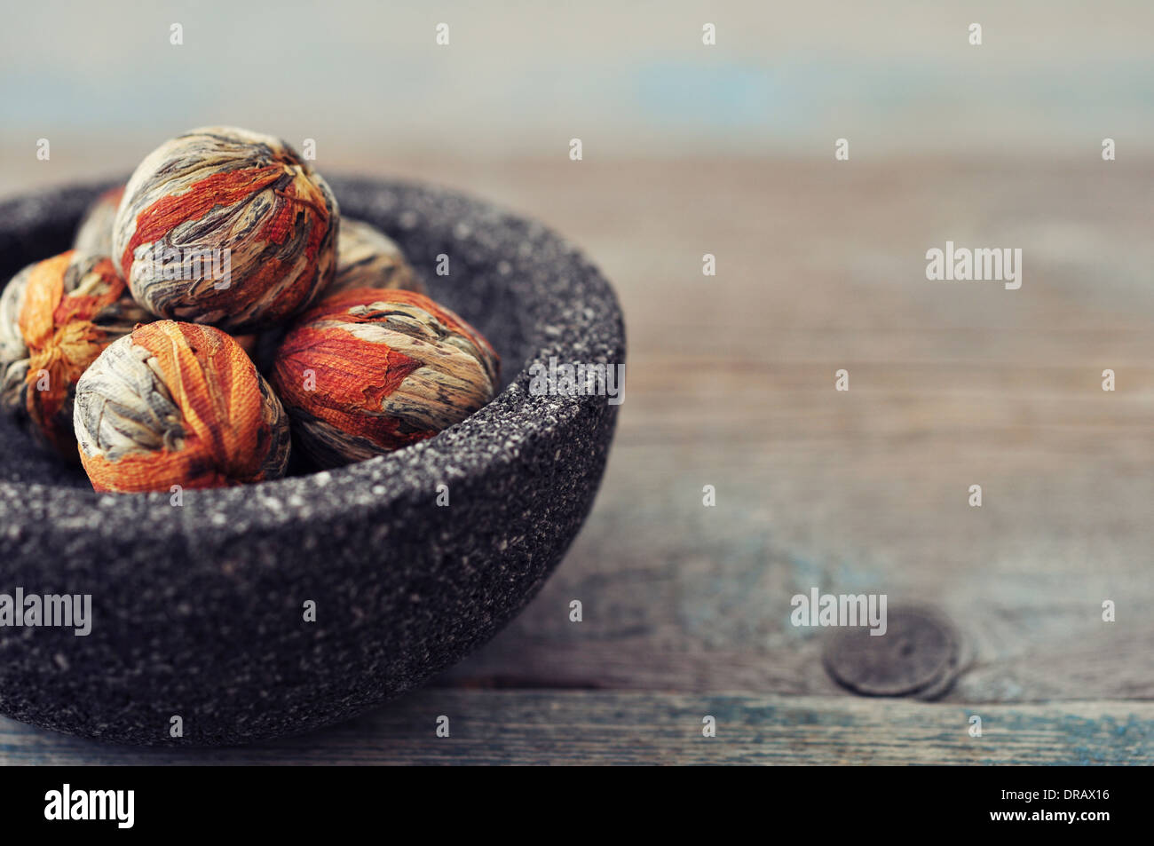 Chinese Green Tea Balls with Lychee Flower in stone bowl on wooden ...
