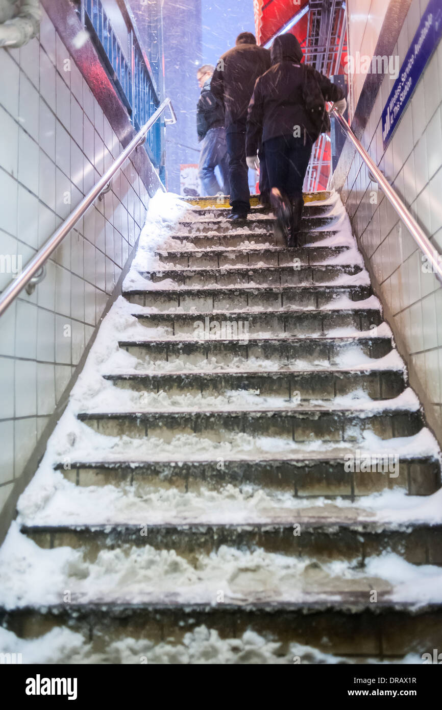 Visitors maneuver icy subway steps in Times Square in New York during a ...
