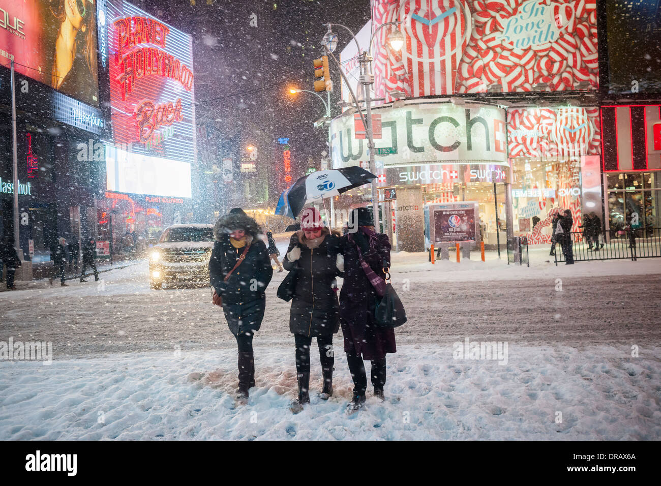 Visitors to Times Square in New York during a snow storm Stock Photo ...