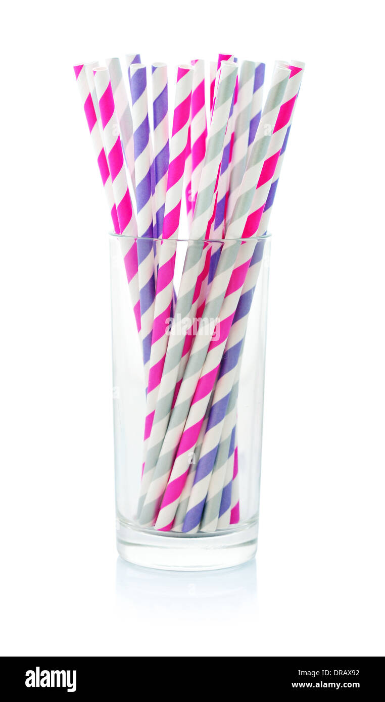Striped drink straws of different colors in glass isolated on white ...