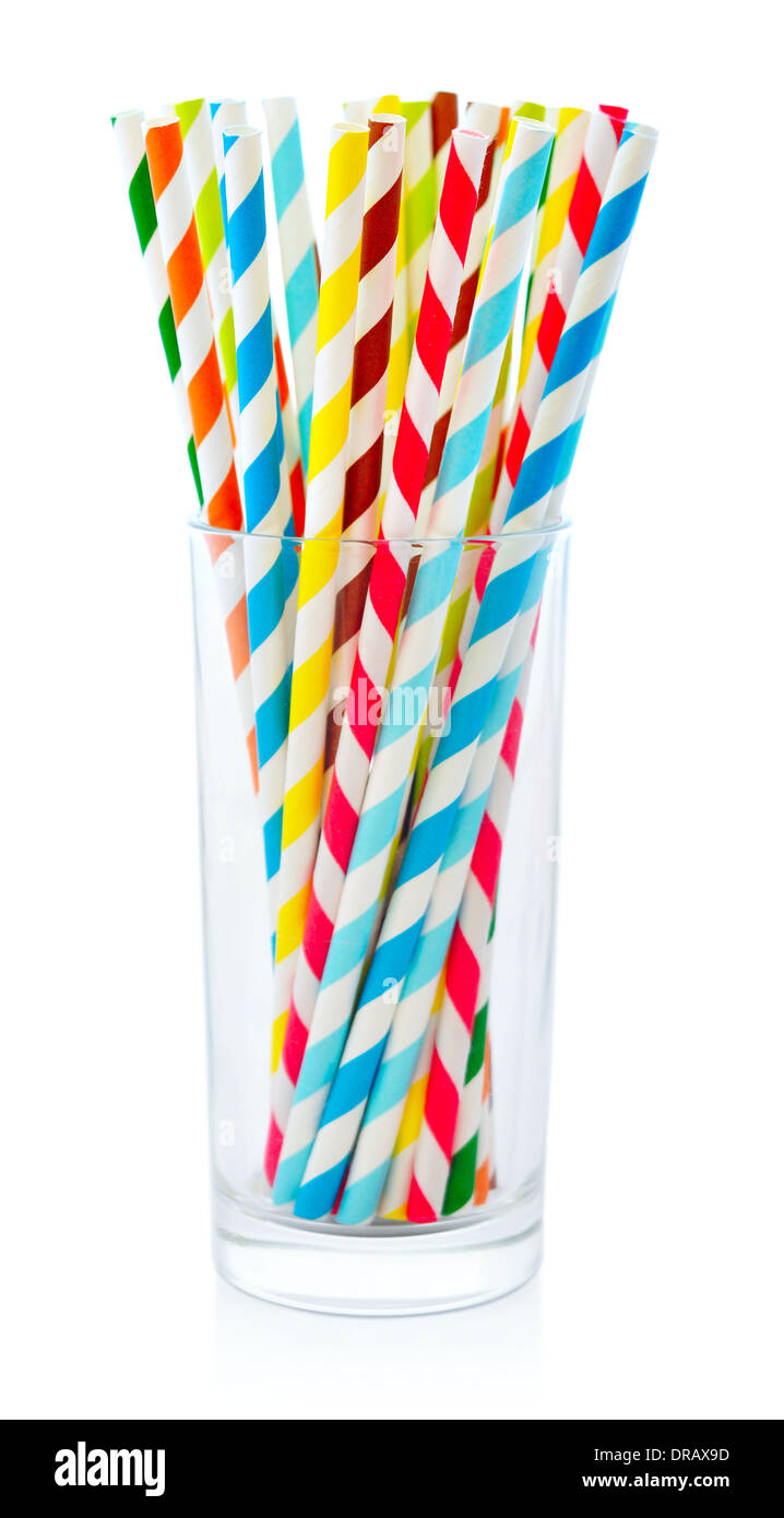 Striped drink straws of different colors in glass isolated on white ...