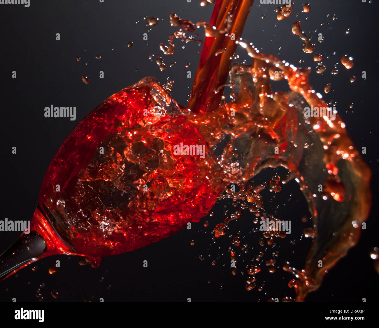 Red wine splashing / spilling out of wine glass Stock Photo - Alamy