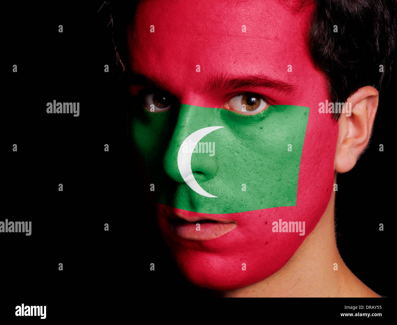 Flag of Maldives Painted on a Face of a Young Man Stock Photo - Alamy