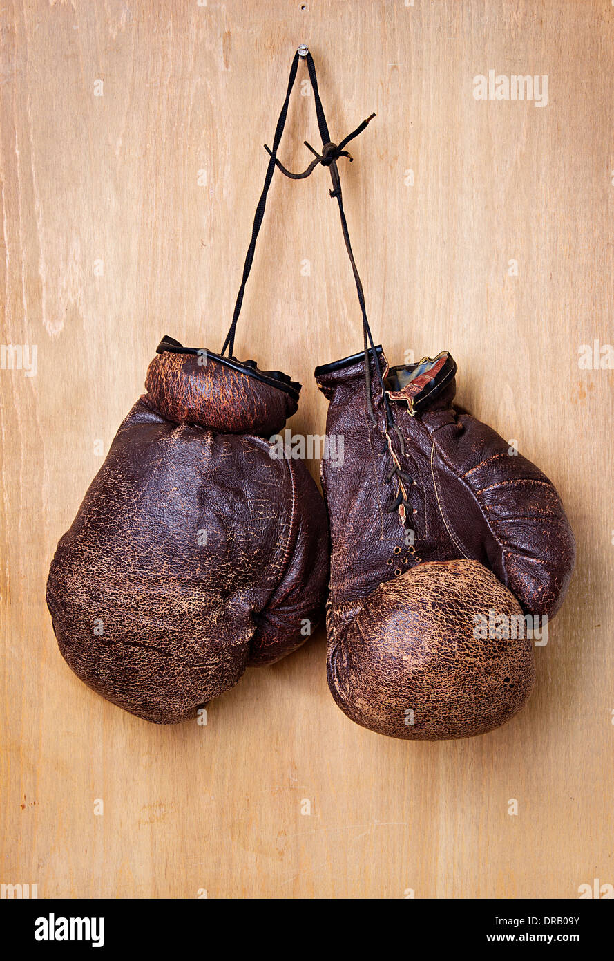 old boxing gloves hang on nail on wall Stock Photo - Alamy