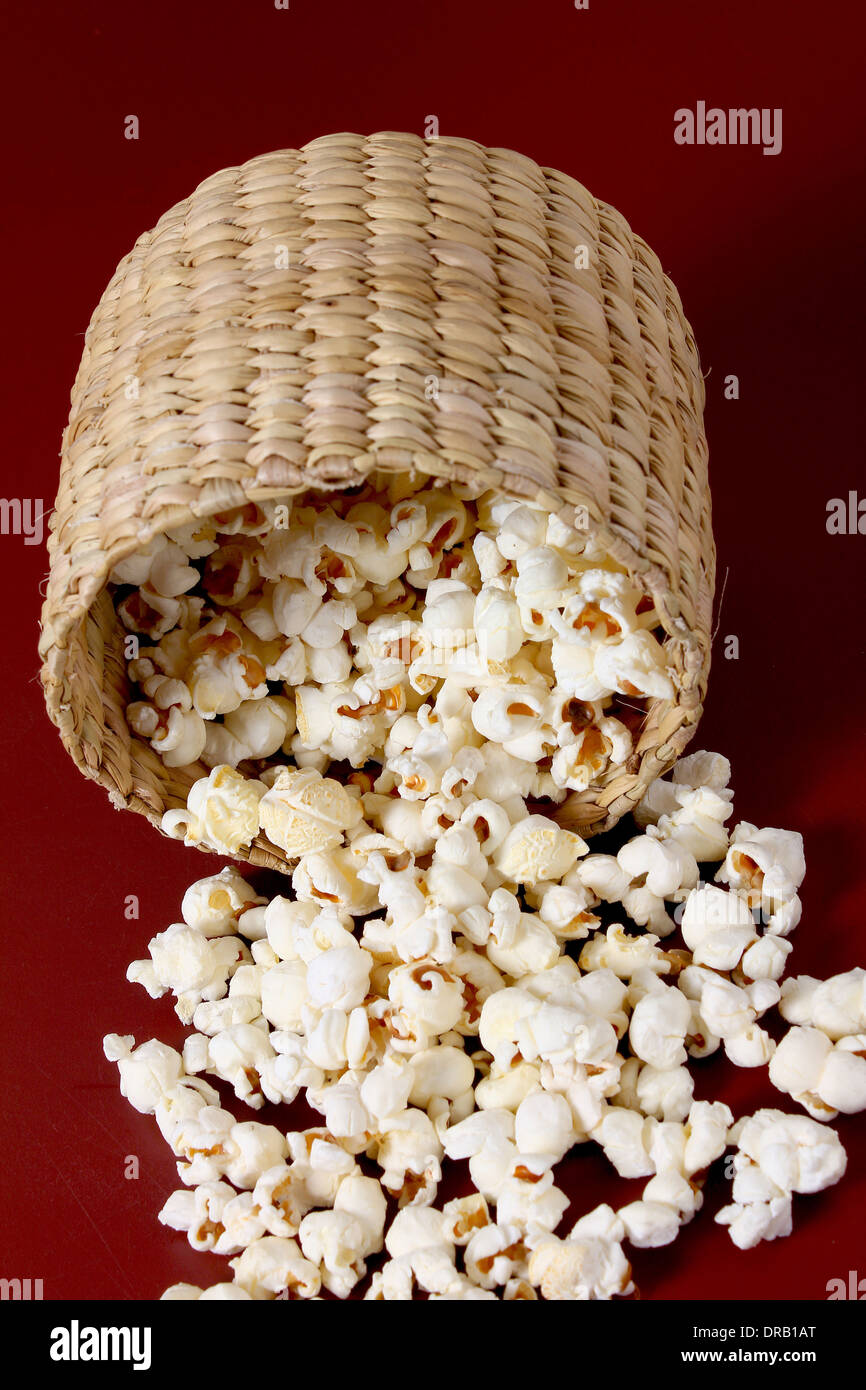 popcorn spreading on red background with bowl Stock Photo - Alamy