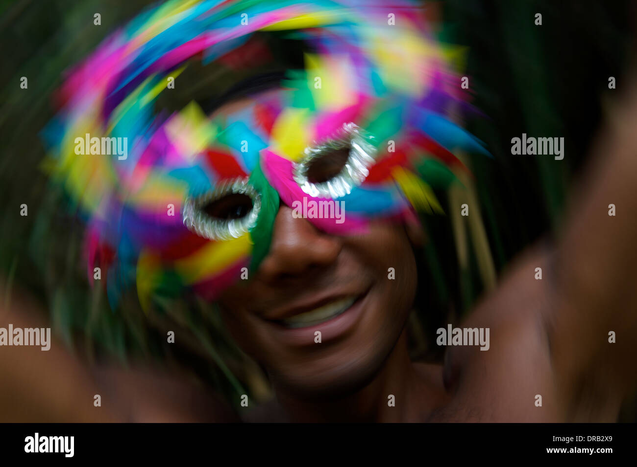 Brazilian man celebrating Carnival in colorful mask in jungle ...