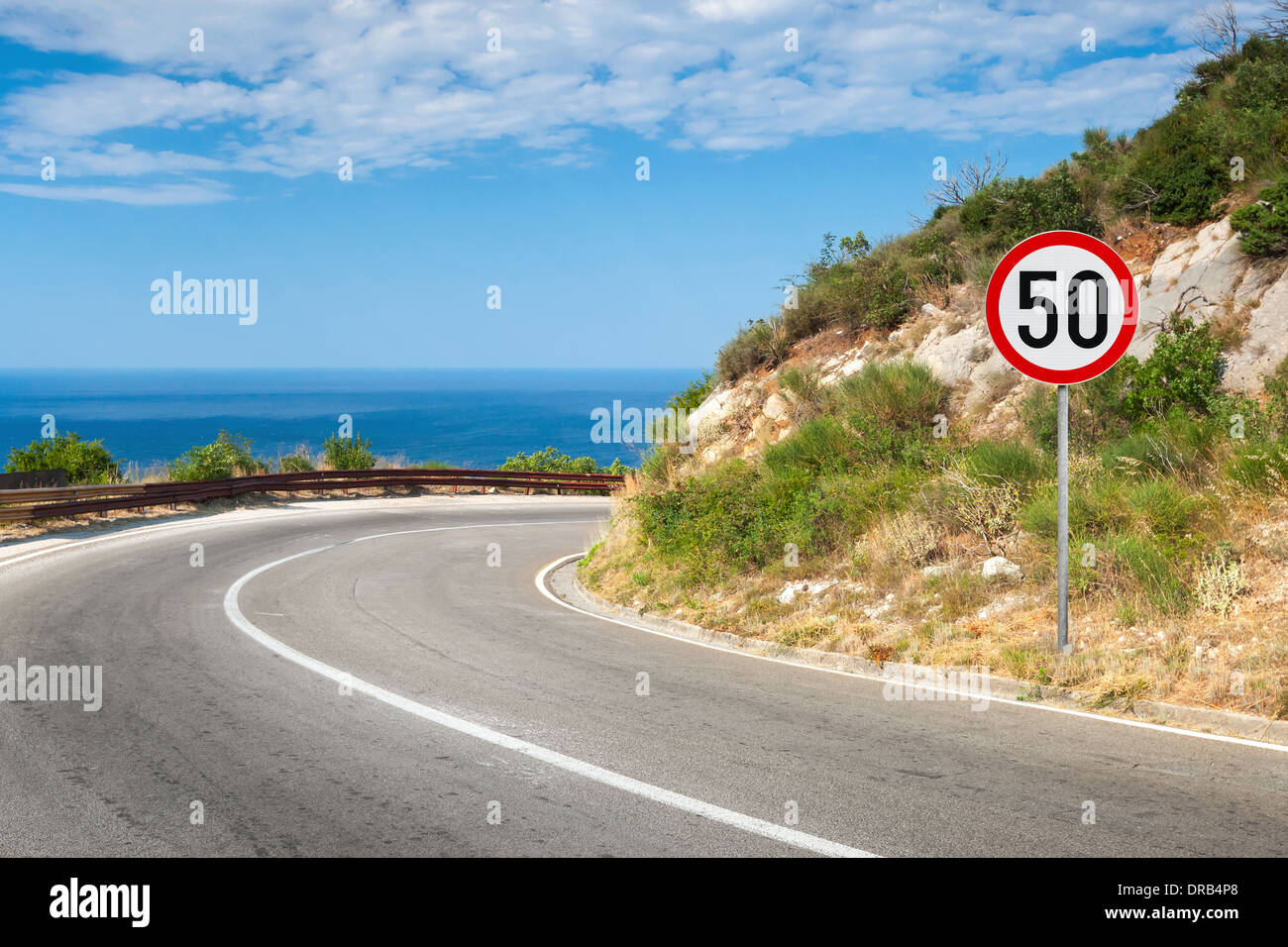 Round speed limit road sign on the roadside Stock Photo - Alamy