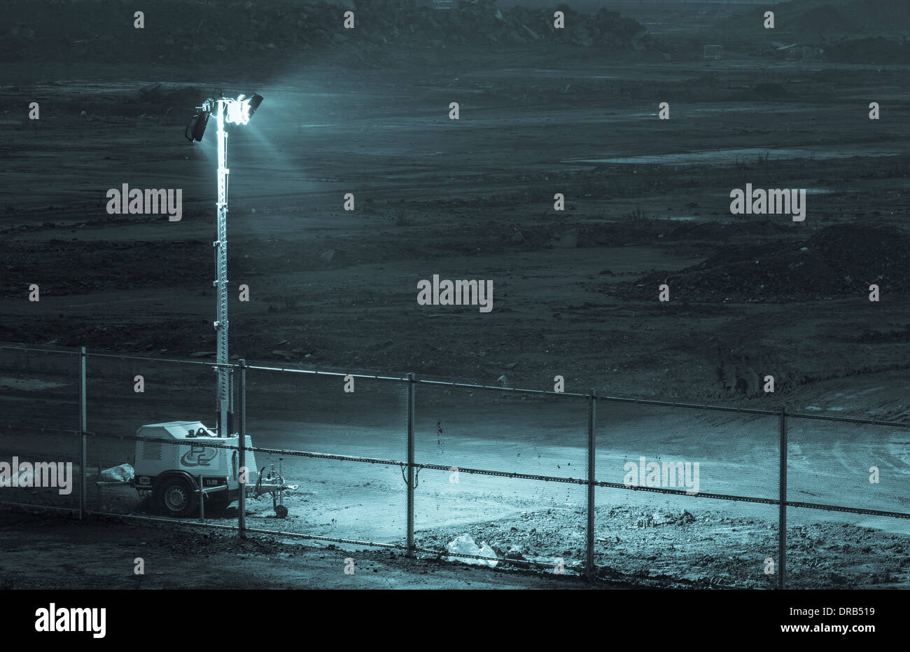 Security light and generator near perimeter fence on new construction ...