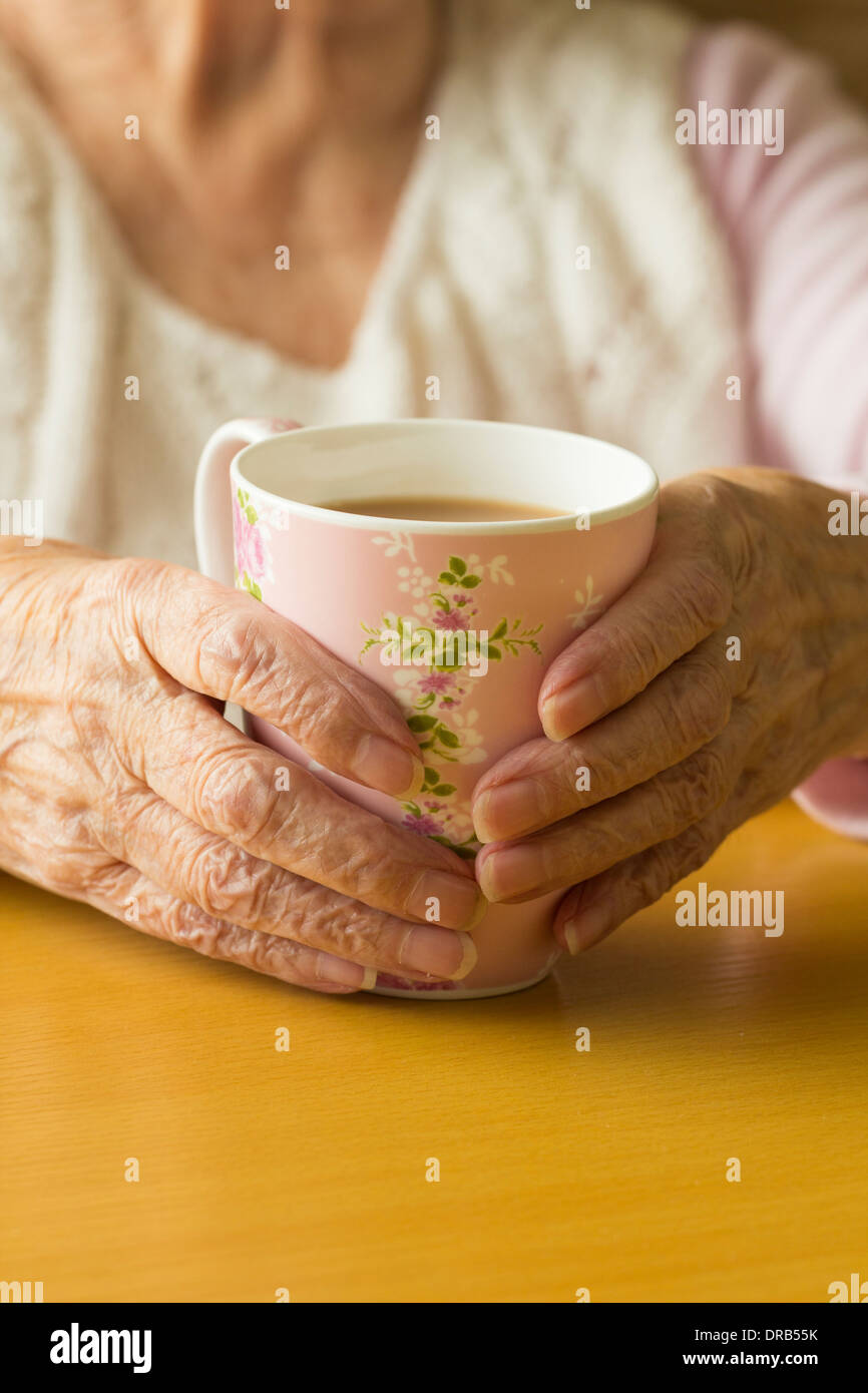 Old lady holding tea cup hi-res stock photography and images - Alamy