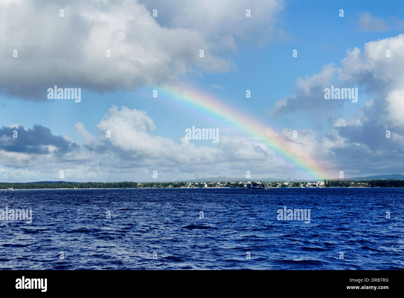 Rainbow over blue ocean in Mauritius Stock Photo - Alamy