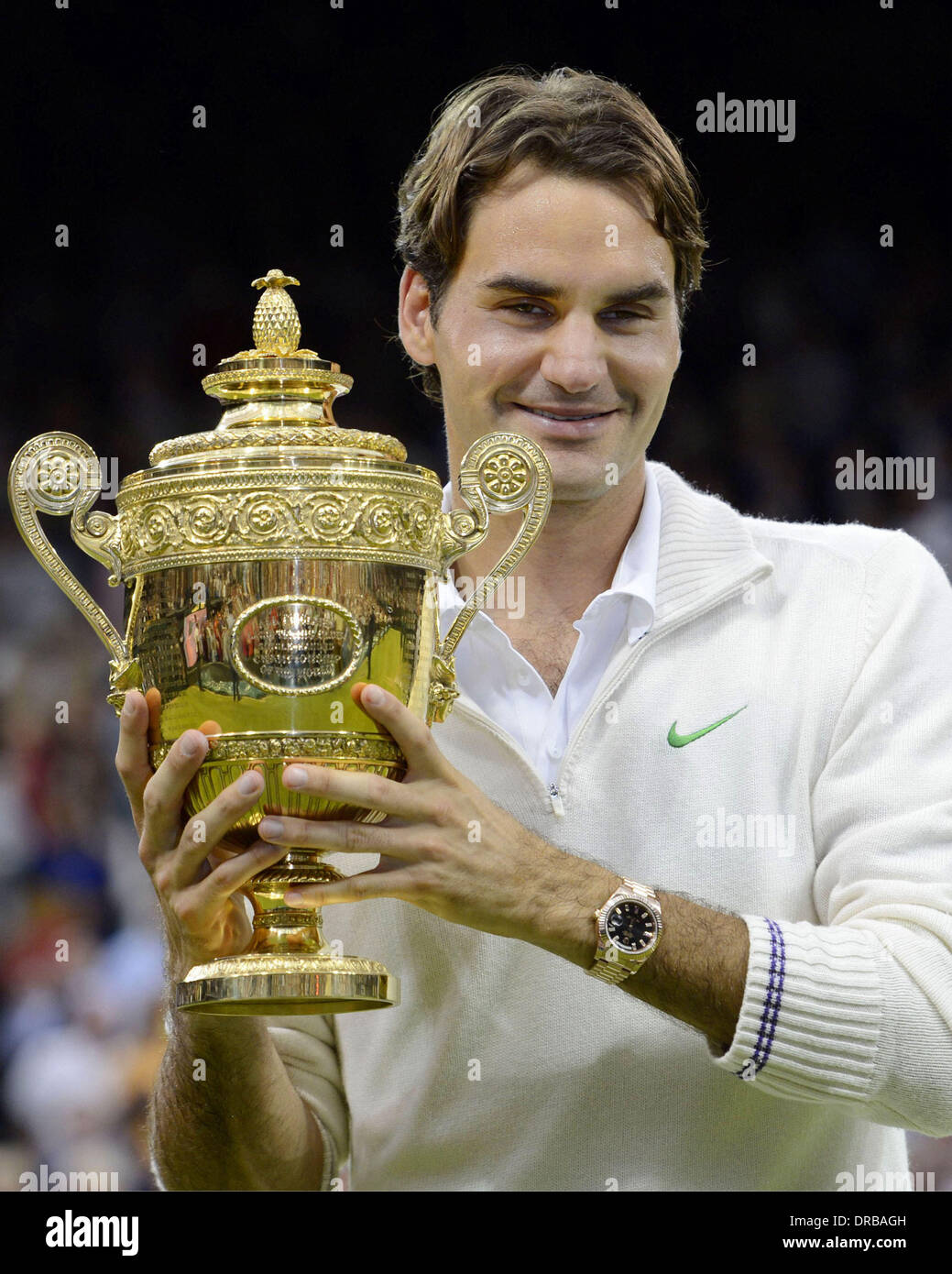 Roger Federer of Switzerland celebrates victory with his trophy after ...