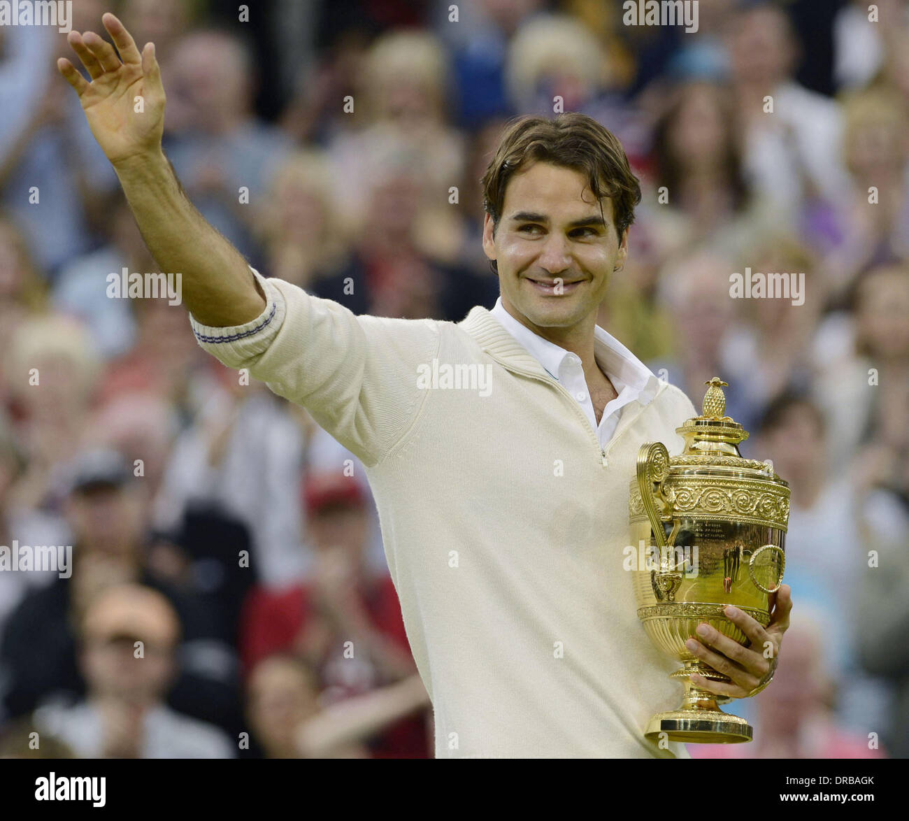 Roger Federer of Switzerland celebrates victory with his trophy after ...