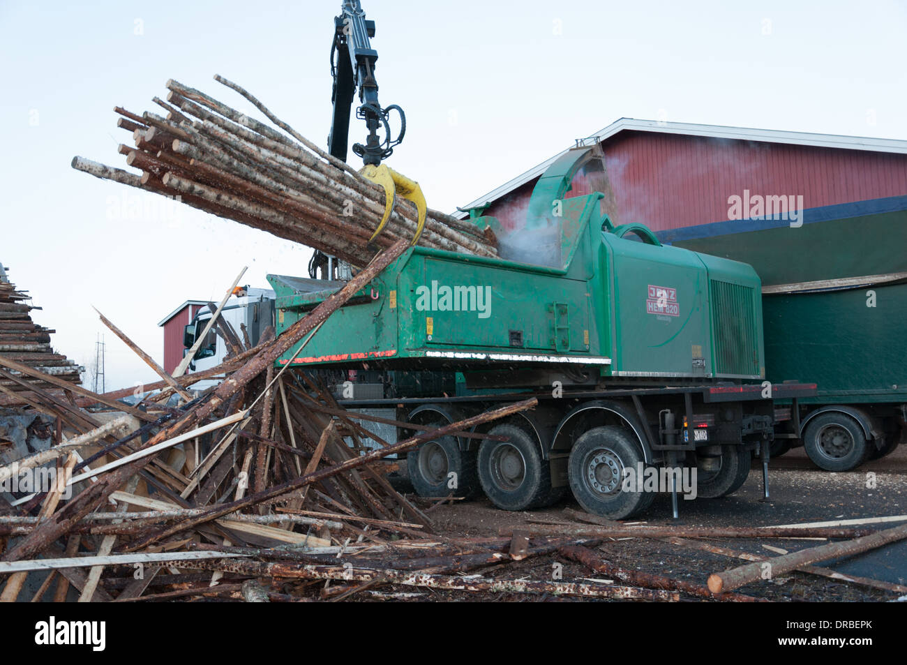 Making wood chips In Finland Stock Photo - Alamy