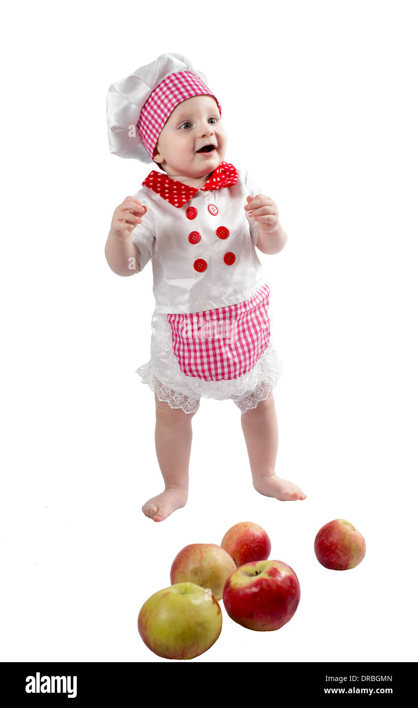 Baby cook girl wearing chef hat with fresh vegetables and fruits. Use ...