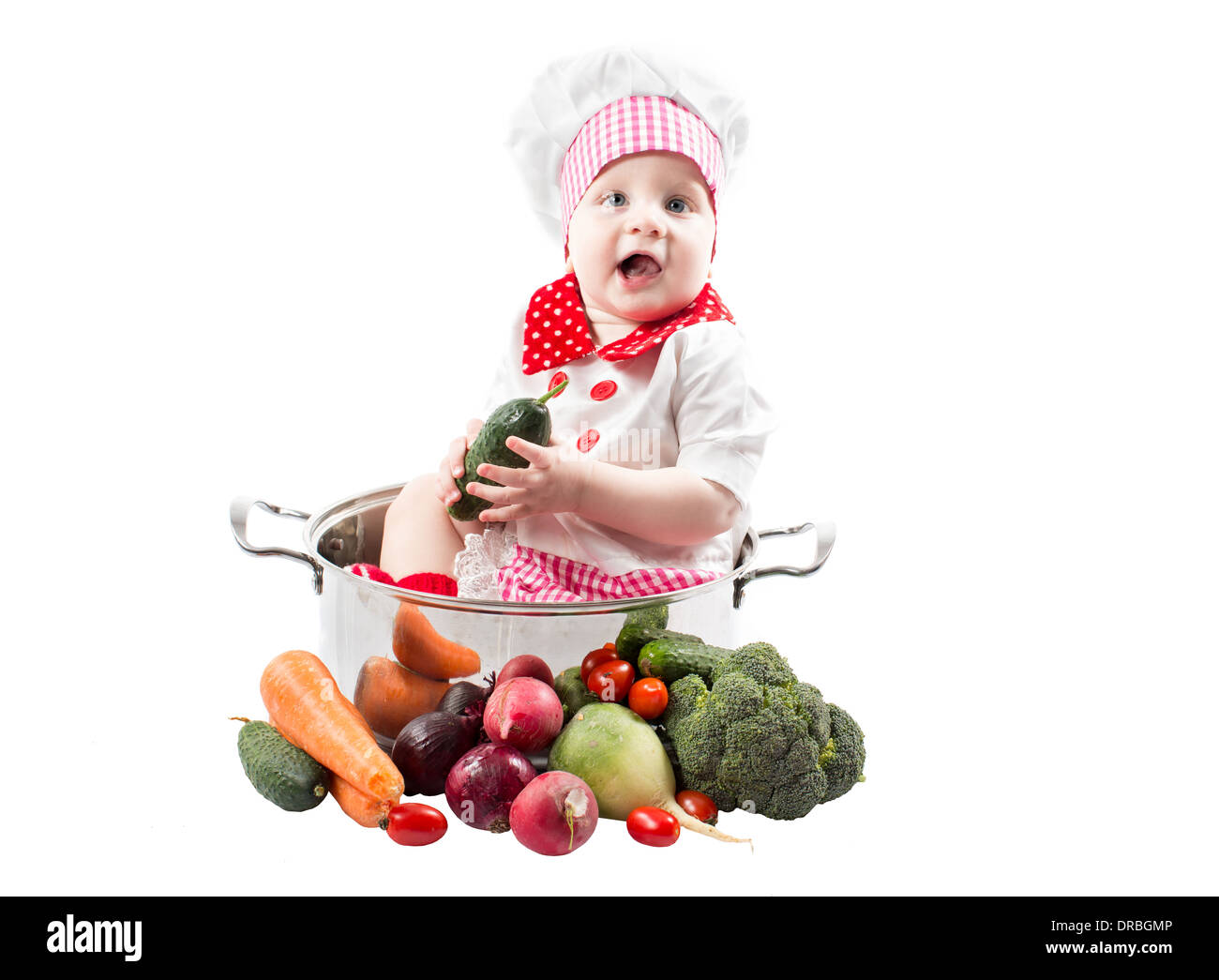 Baby cook girl wearing chef hat with fresh vegetables and fruits. Use ...