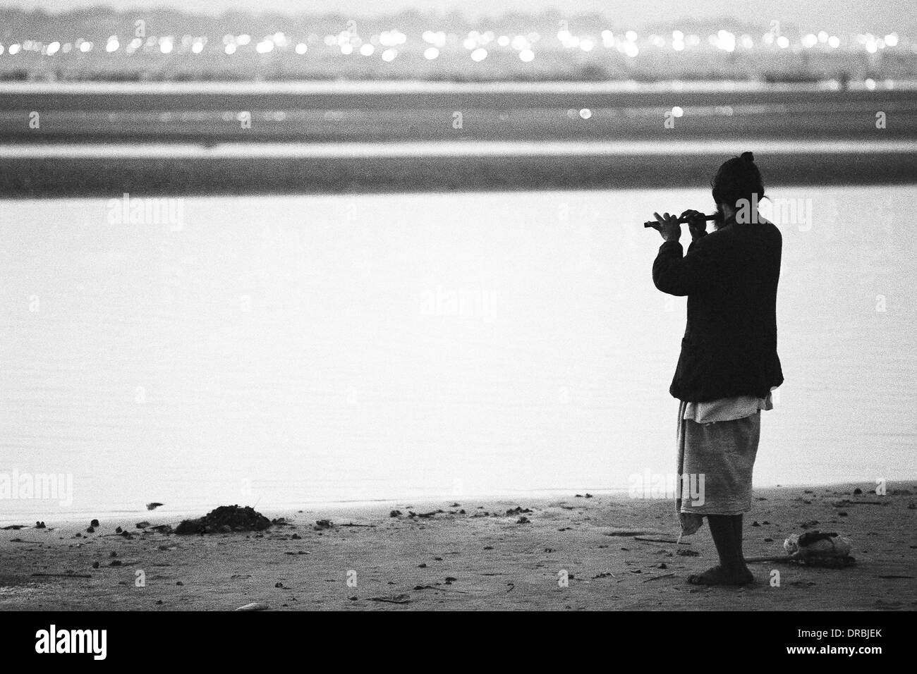 Indian man playing the flute Black and White Stock Photos & Images - Alamy