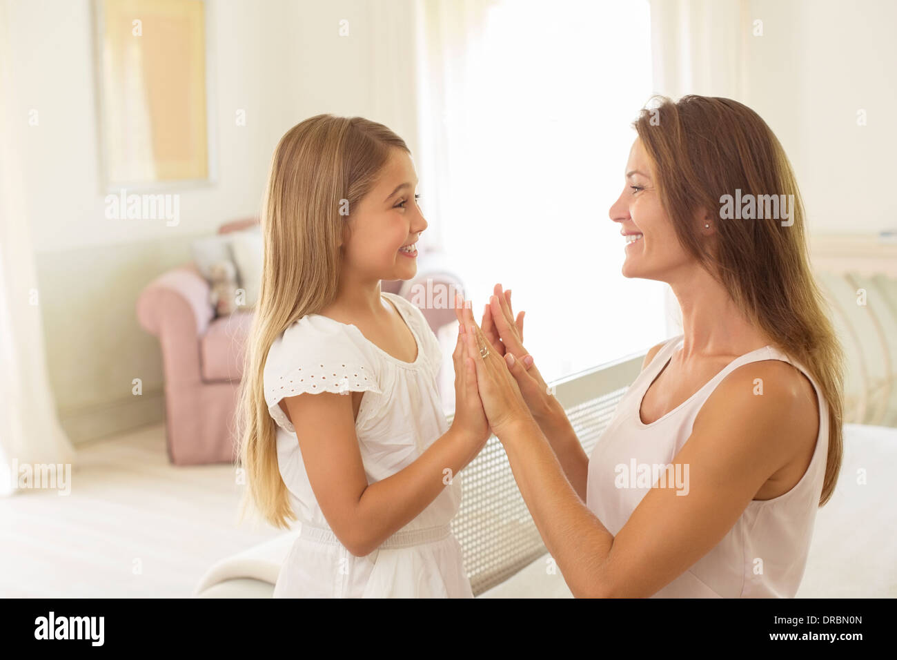 Mother and daughter touching hands Stock Photo - Alamy