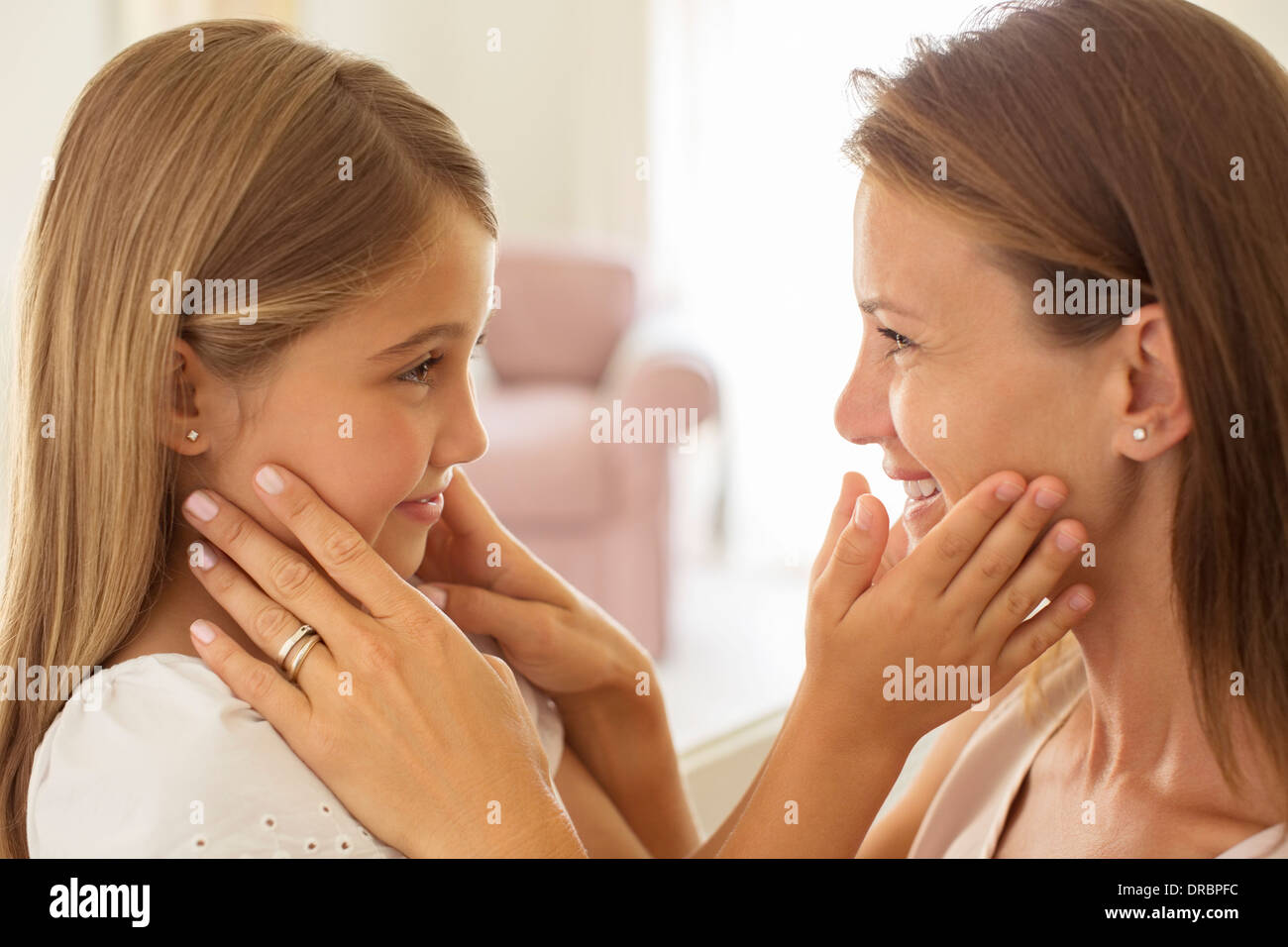 Mother and daughter touching faces Stock Photo - Alamy