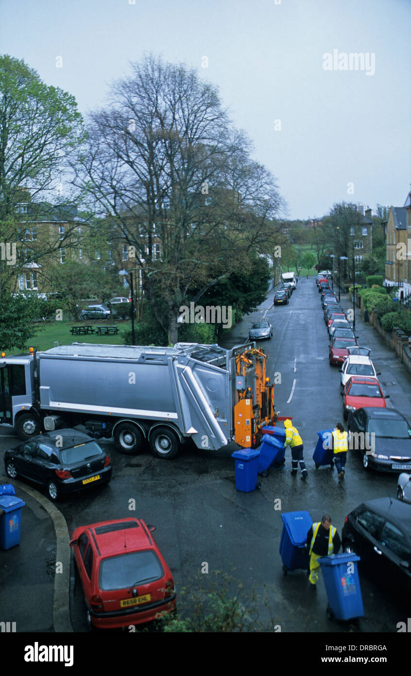 Refuse collectors emptying recycling bins in a suburban London street ...