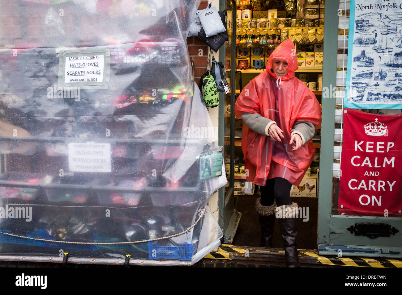 woman and shop in rain wearing plastic mac Stock Photo - Alamy
