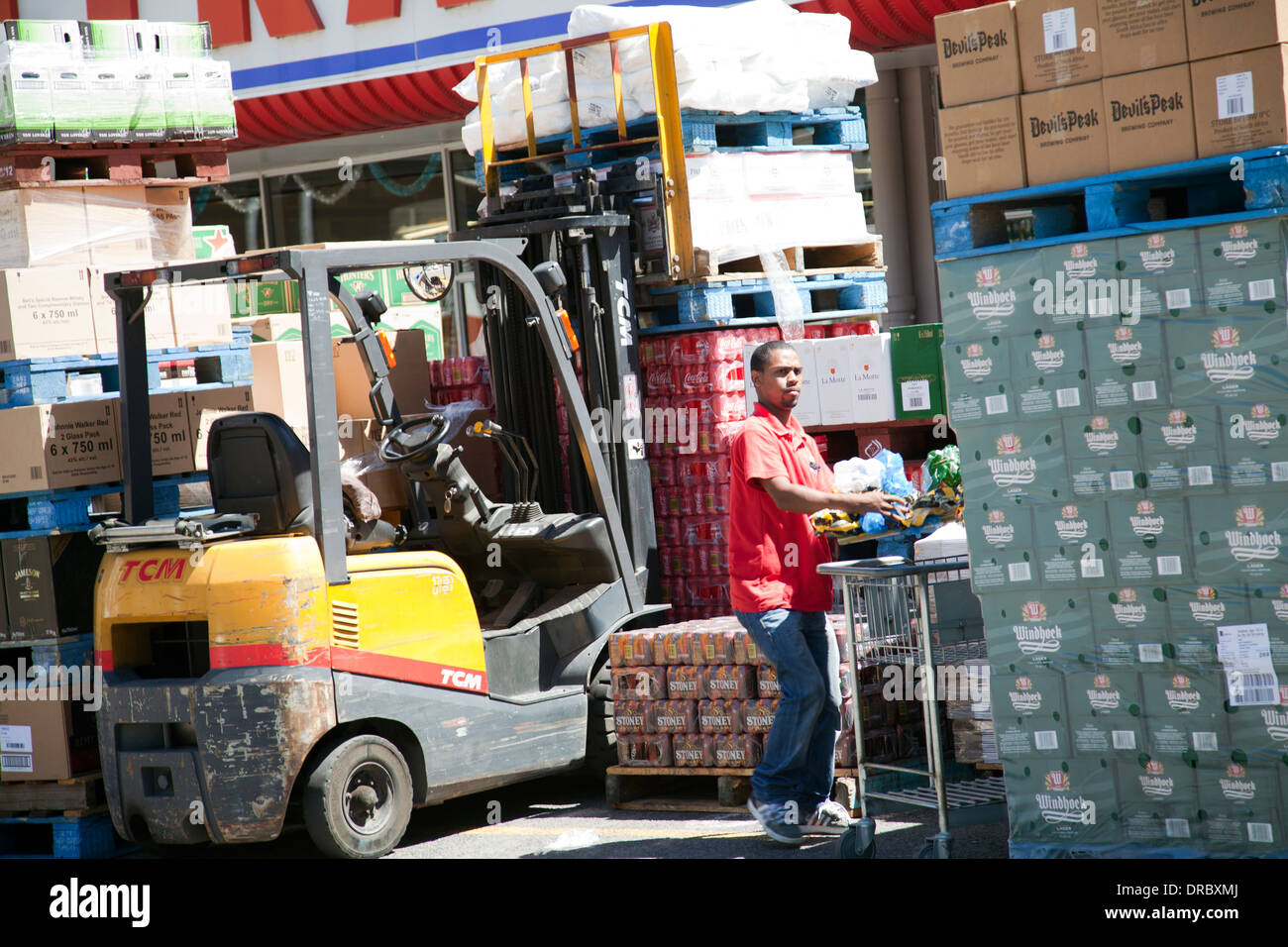 Employee Unpacking Containers of Beverages at Liquor Store in Cape Town ...