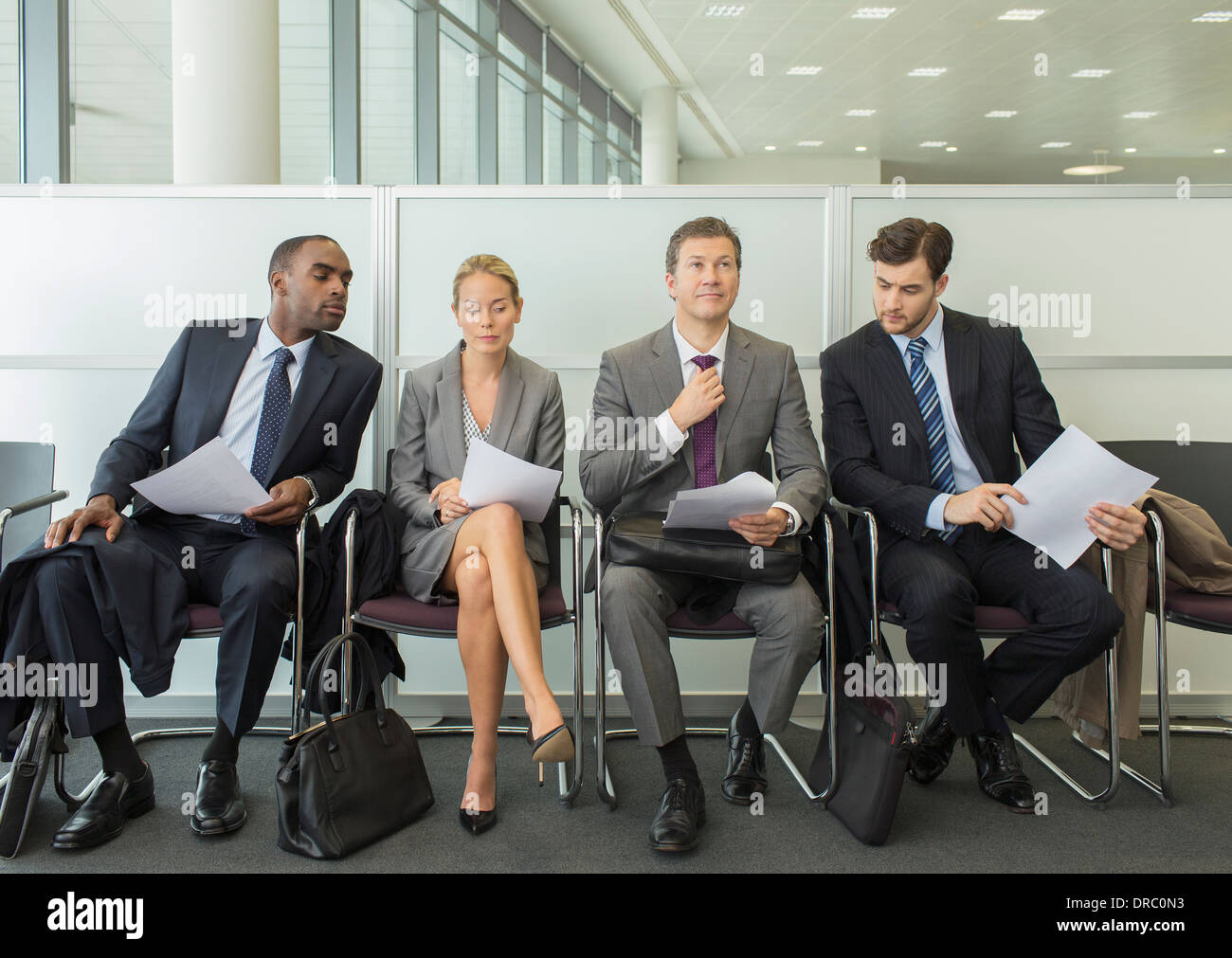 Business people sitting in waiting area Stock Photo - Alamy