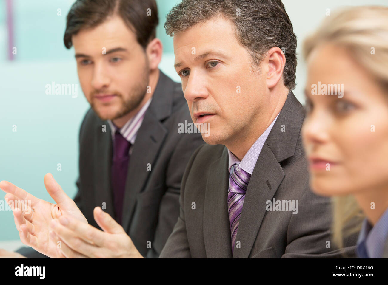 Business people speaking together in conference room in the office ...