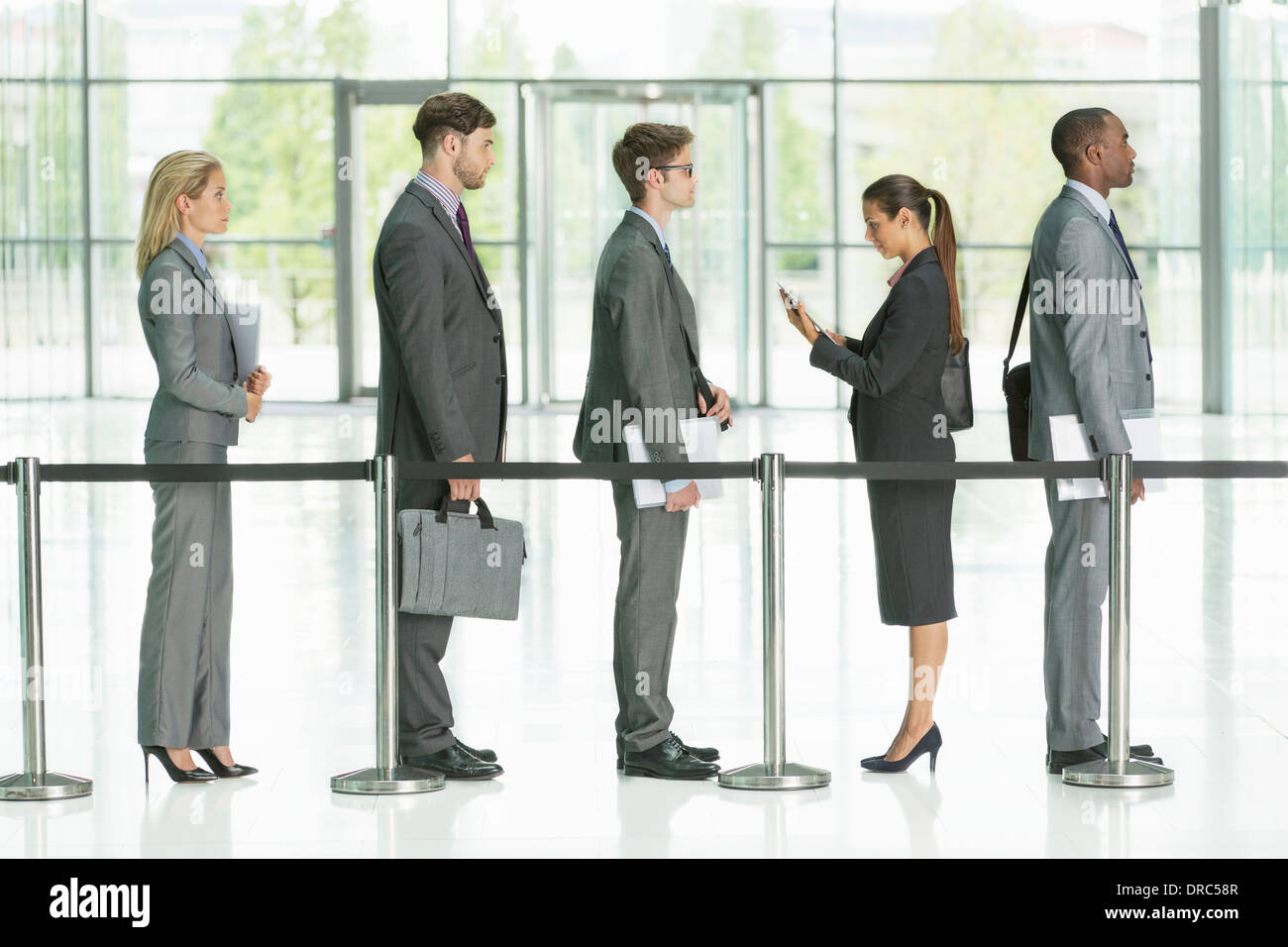Business people waiting in line Stock Photo - Alamy