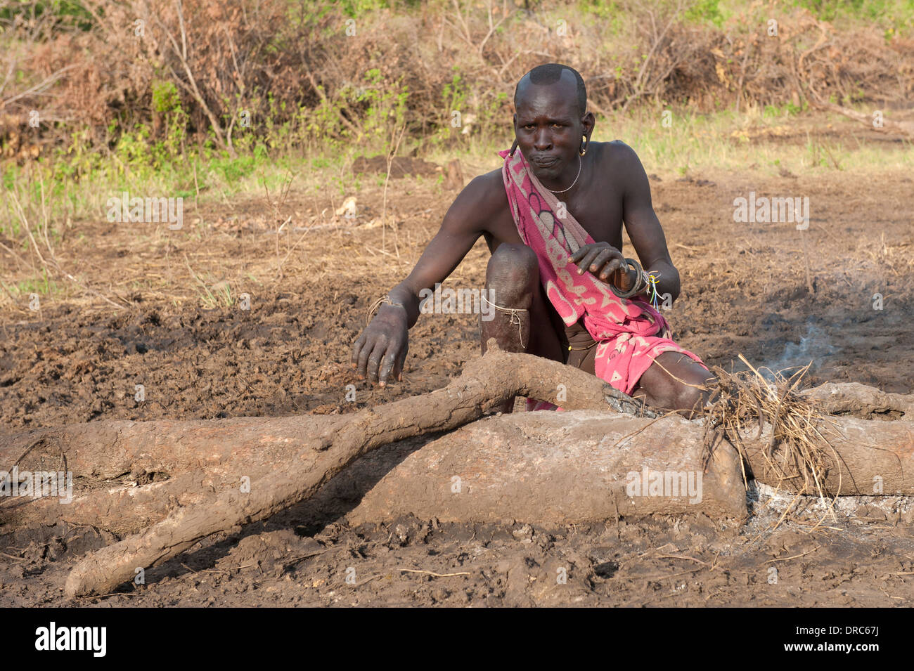 Surma herder making fire in a cattle camp, Omo River Valley, Ethiopia ...