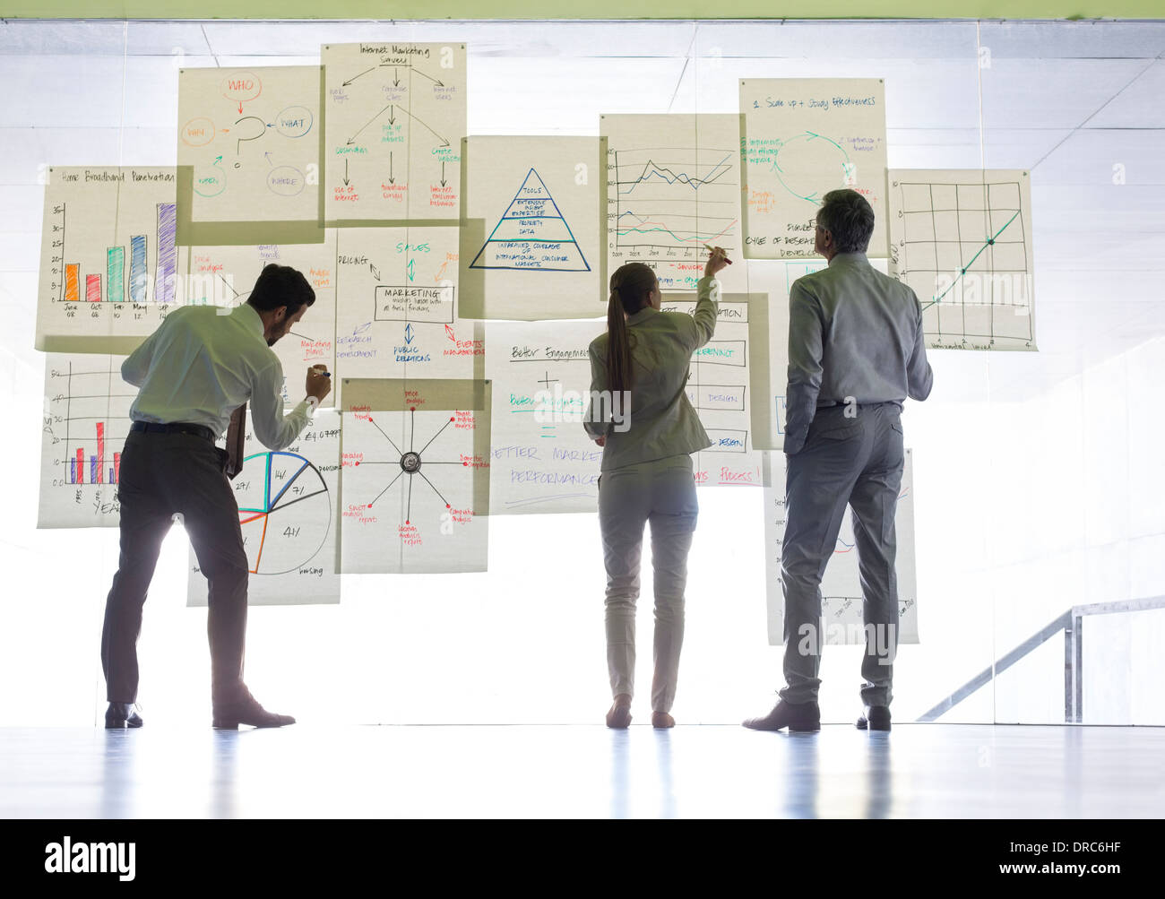 Business people working with charts and graphs on glass wall Stock ...